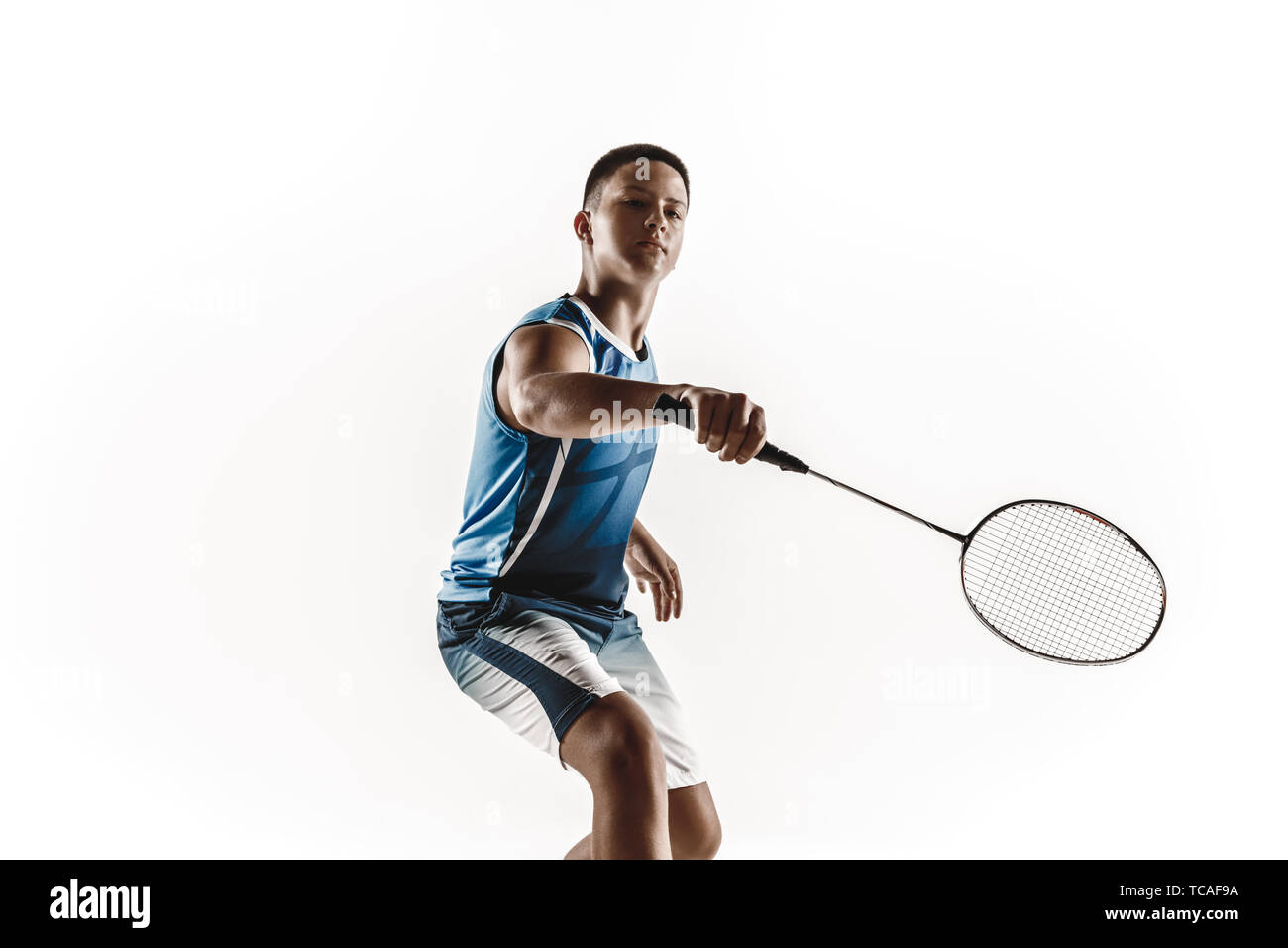 Little boy playing badminton isolated on white studio background. Young ...