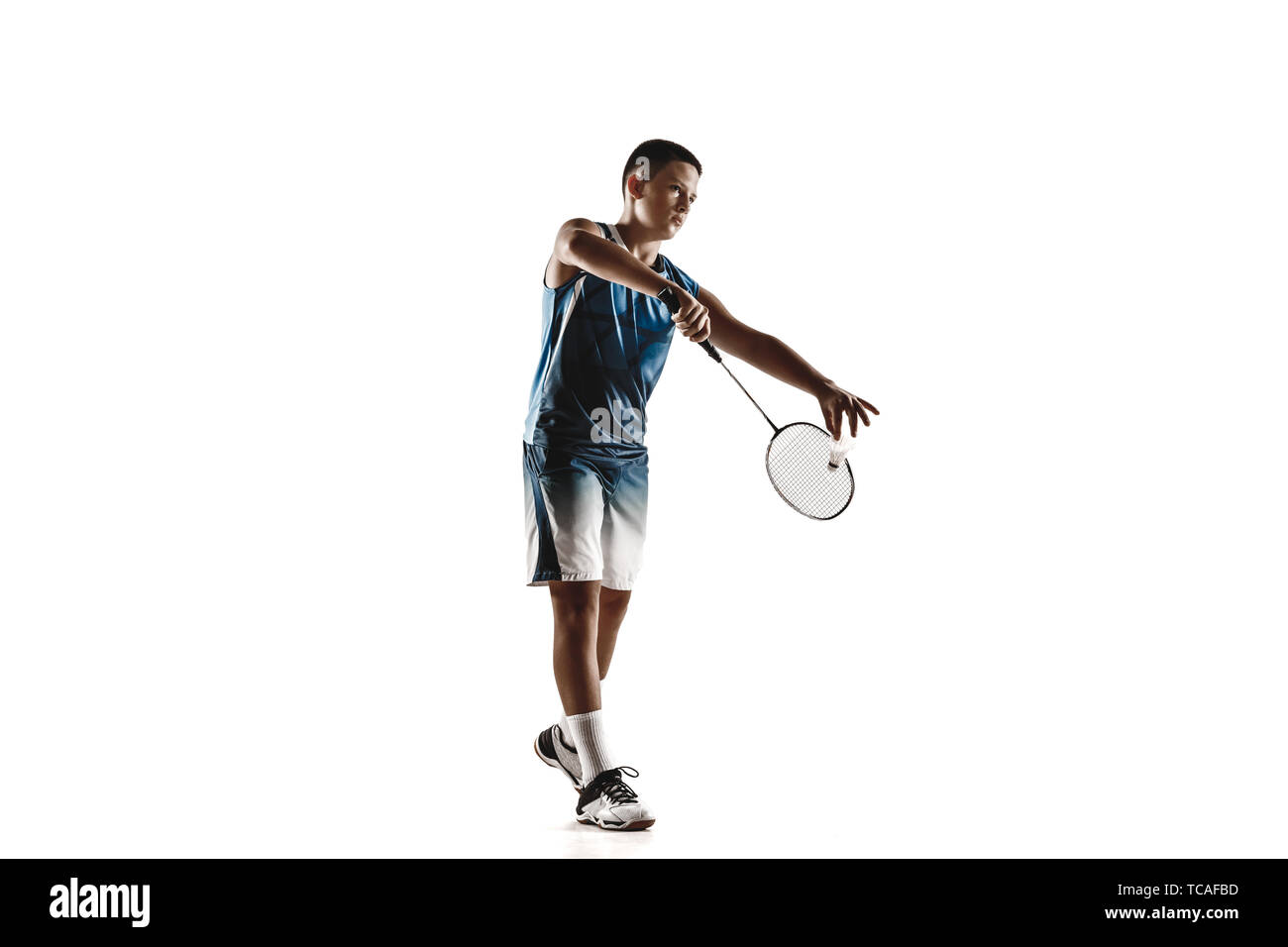 Little boy playing badminton isolated on white studio background. Young ...