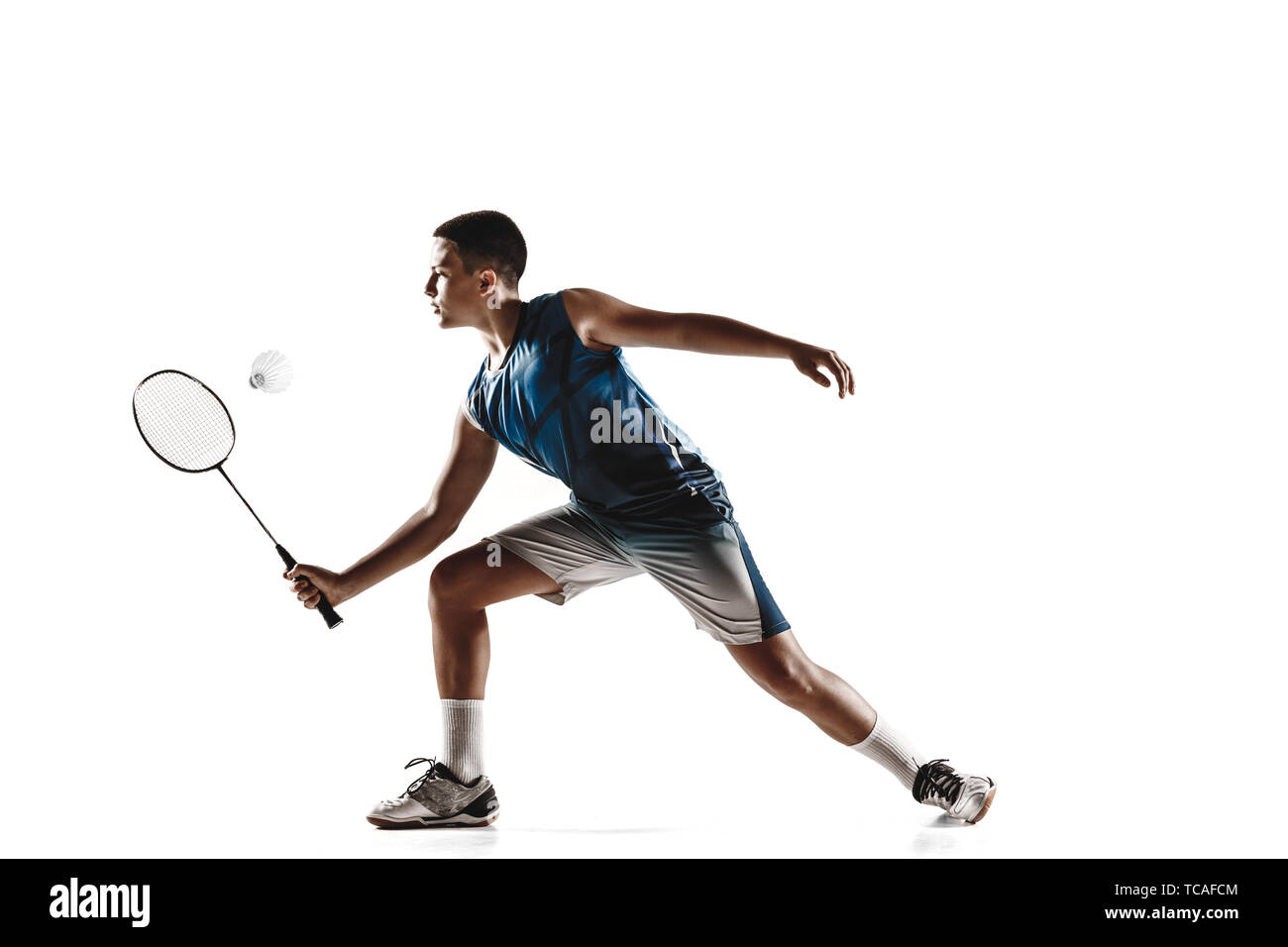 Little boy playing badminton isolated on white studio background. Young ...