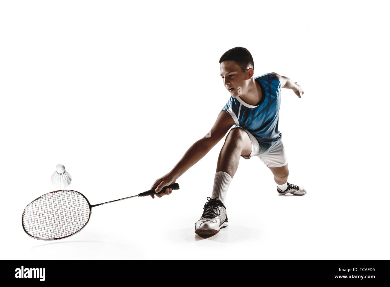 Little boy playing badminton isolated on white studio background. Young ...