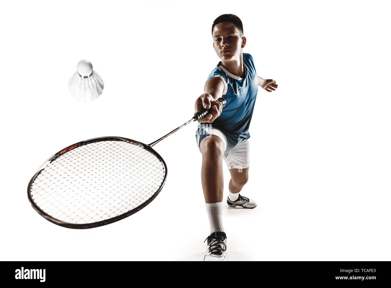 Little boy playing badminton isolated on white studio background. Young ...