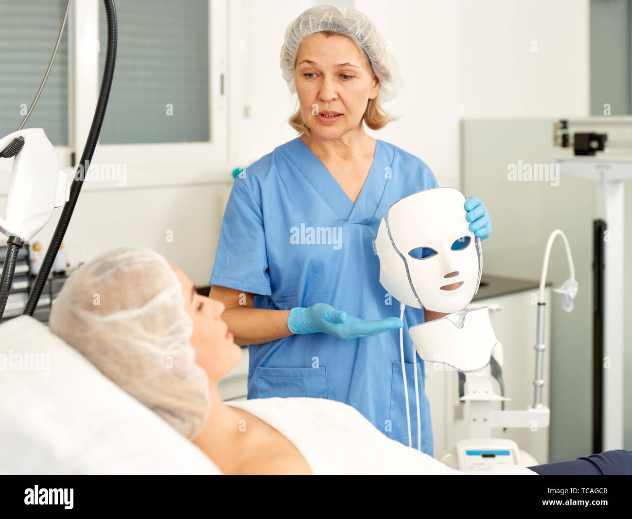 Modern plastic surgeon preparing for operation on woman face Stock ...