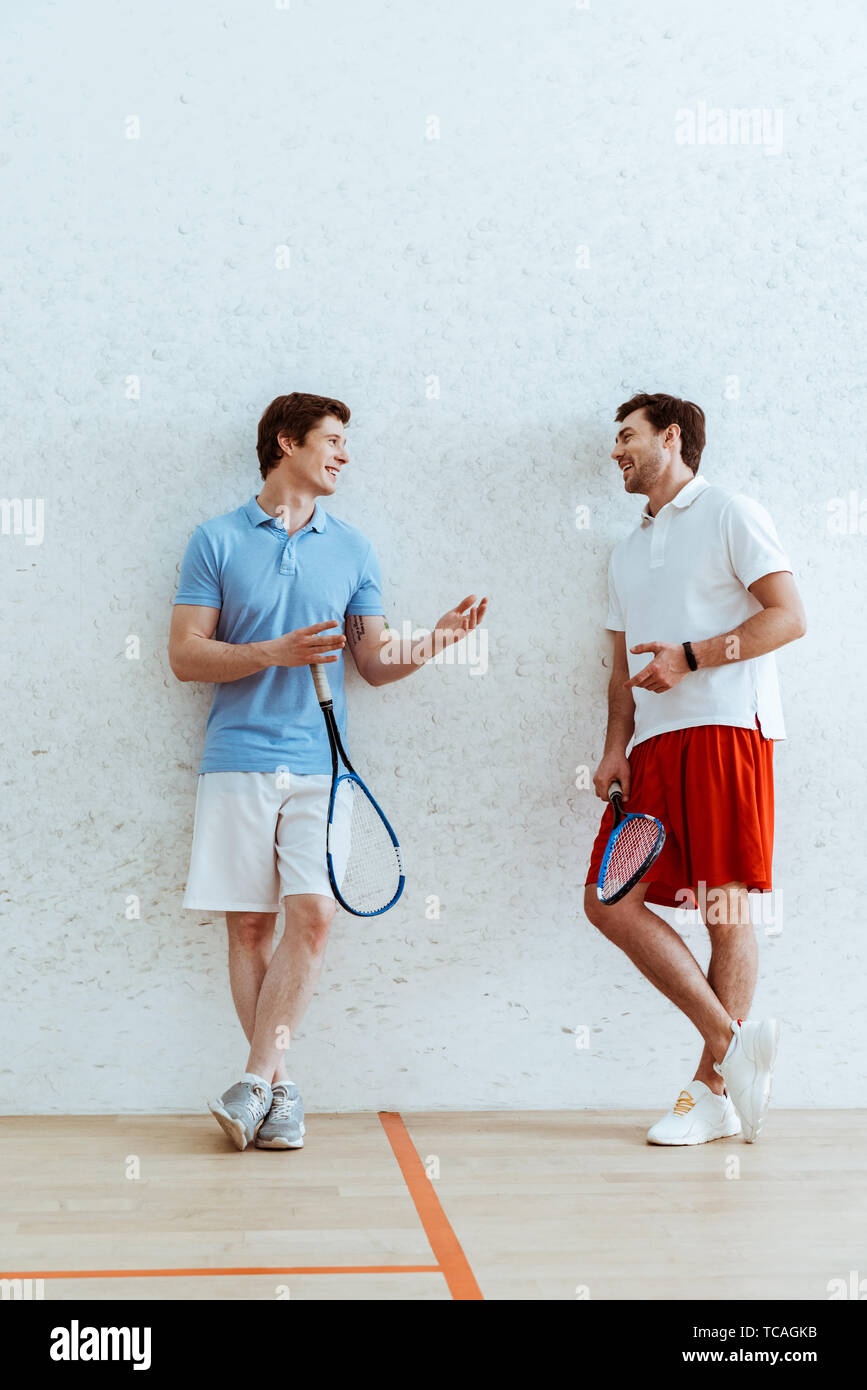 Full length view of squash players talking and looking at each other ...