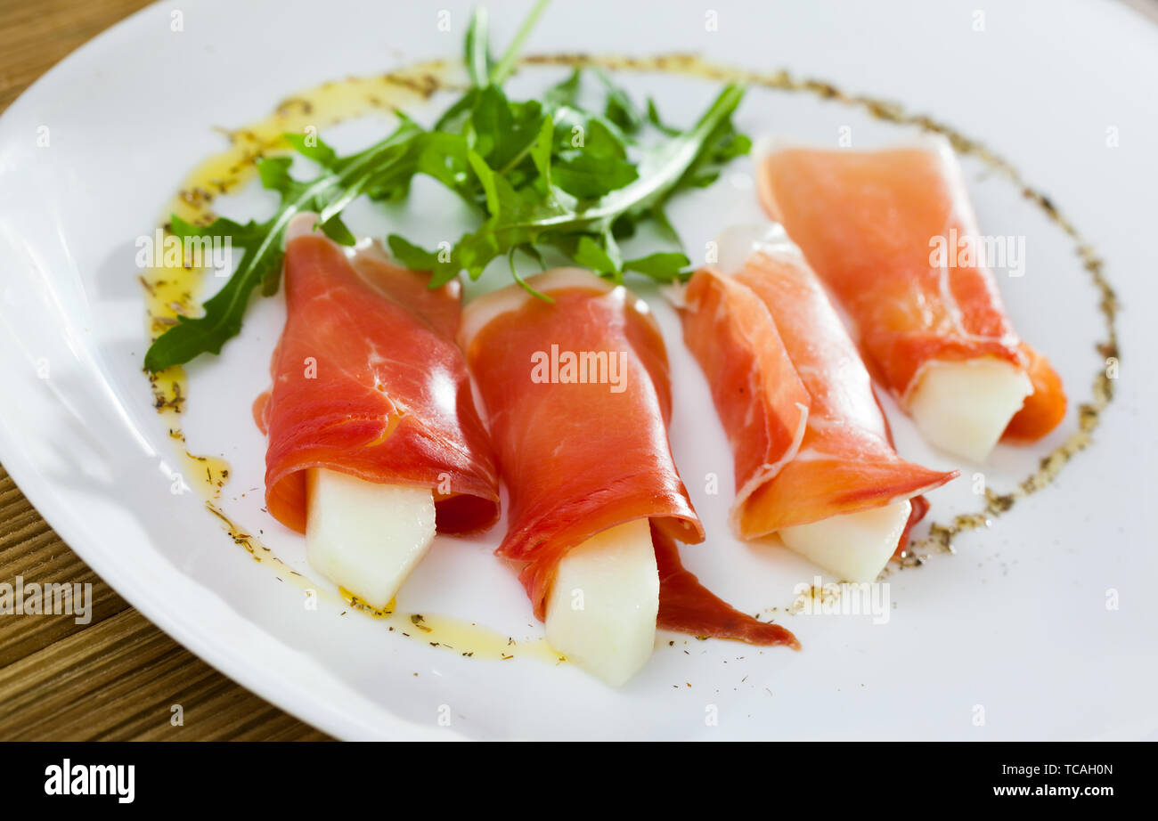 Traditional Spanish dish – jamon with slice of fresh melon Stock Photo ...