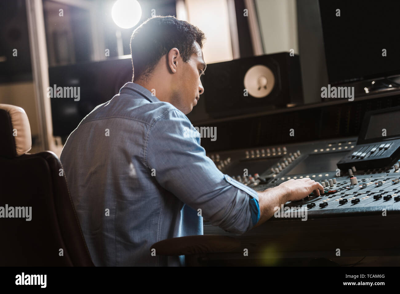 concentrated mixed race sound producer working at mixing console Stock ...