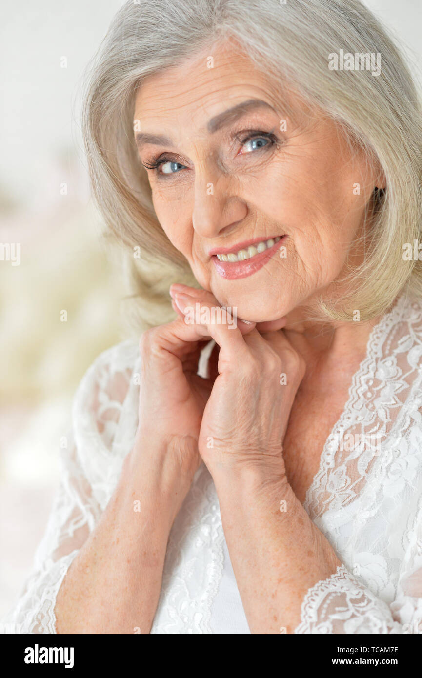 Happy beautiful senior woman posing at home Stock Photo - Alamy