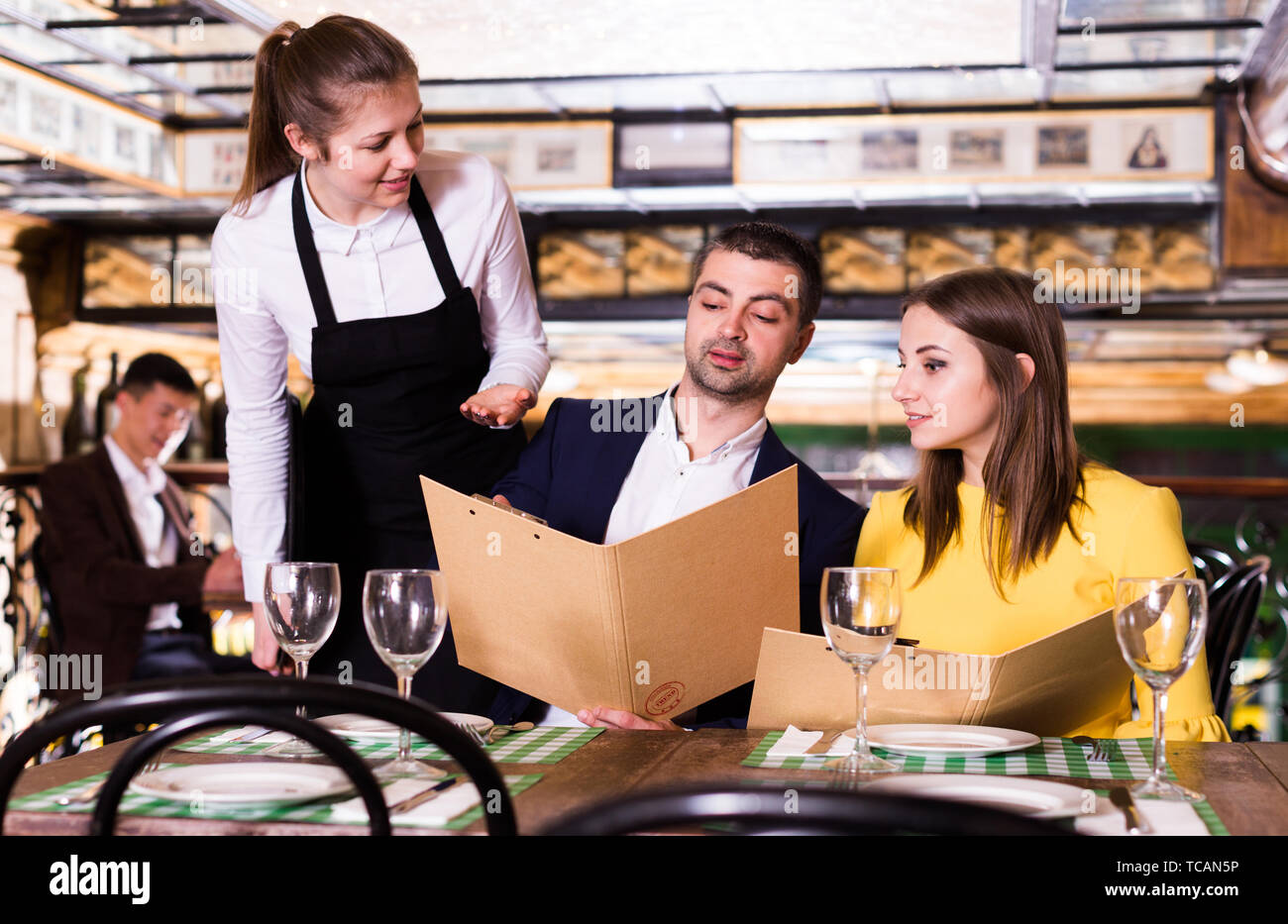 Waiters And Waitresses Taking Orders