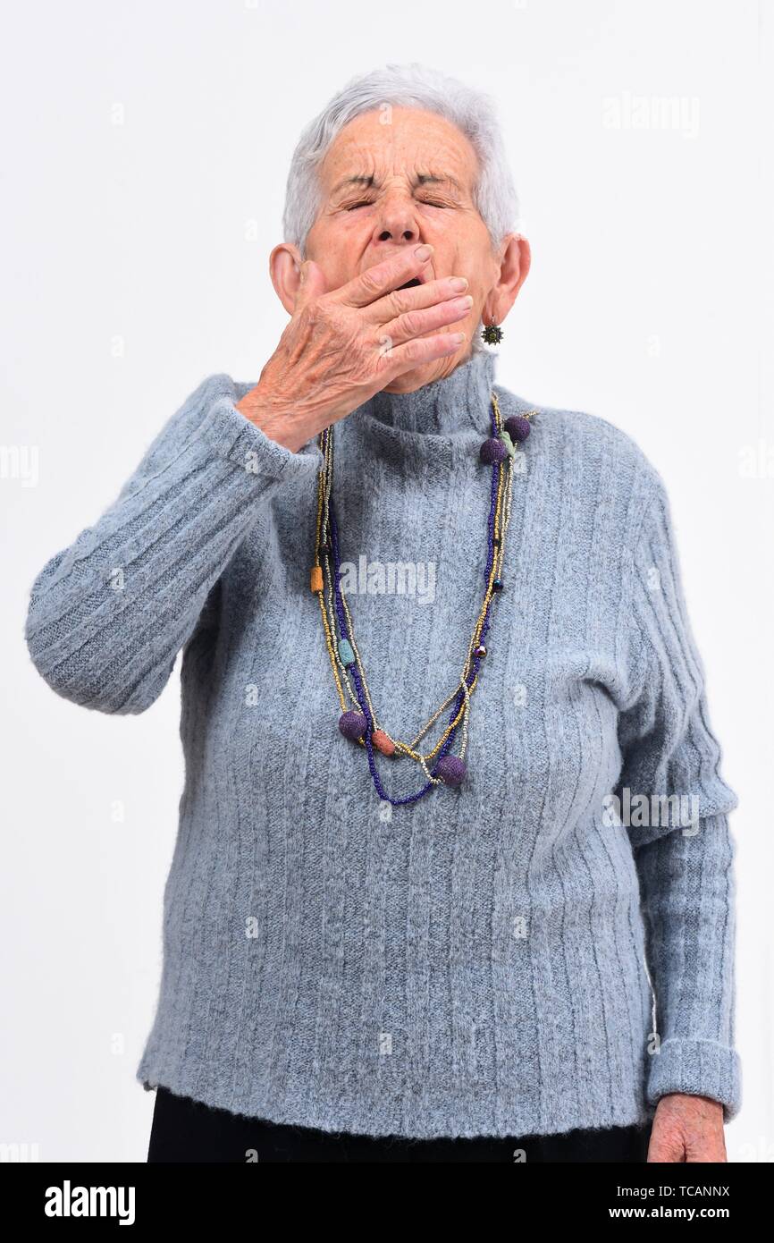 Senior woman yawning on white background Stock Photo - Alamy