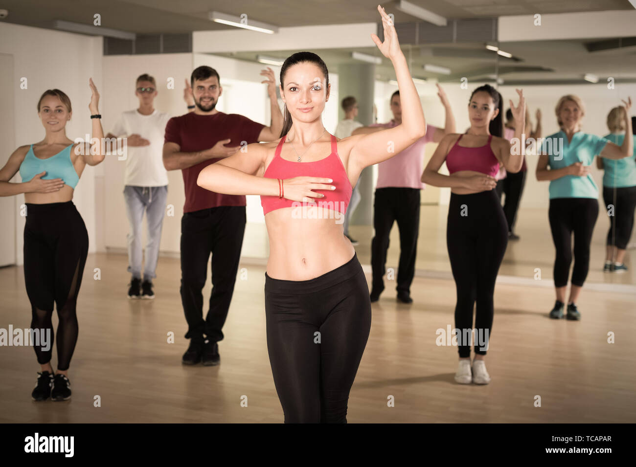 Group of active people training dance together in fitness studio Stock Photo - Alamy