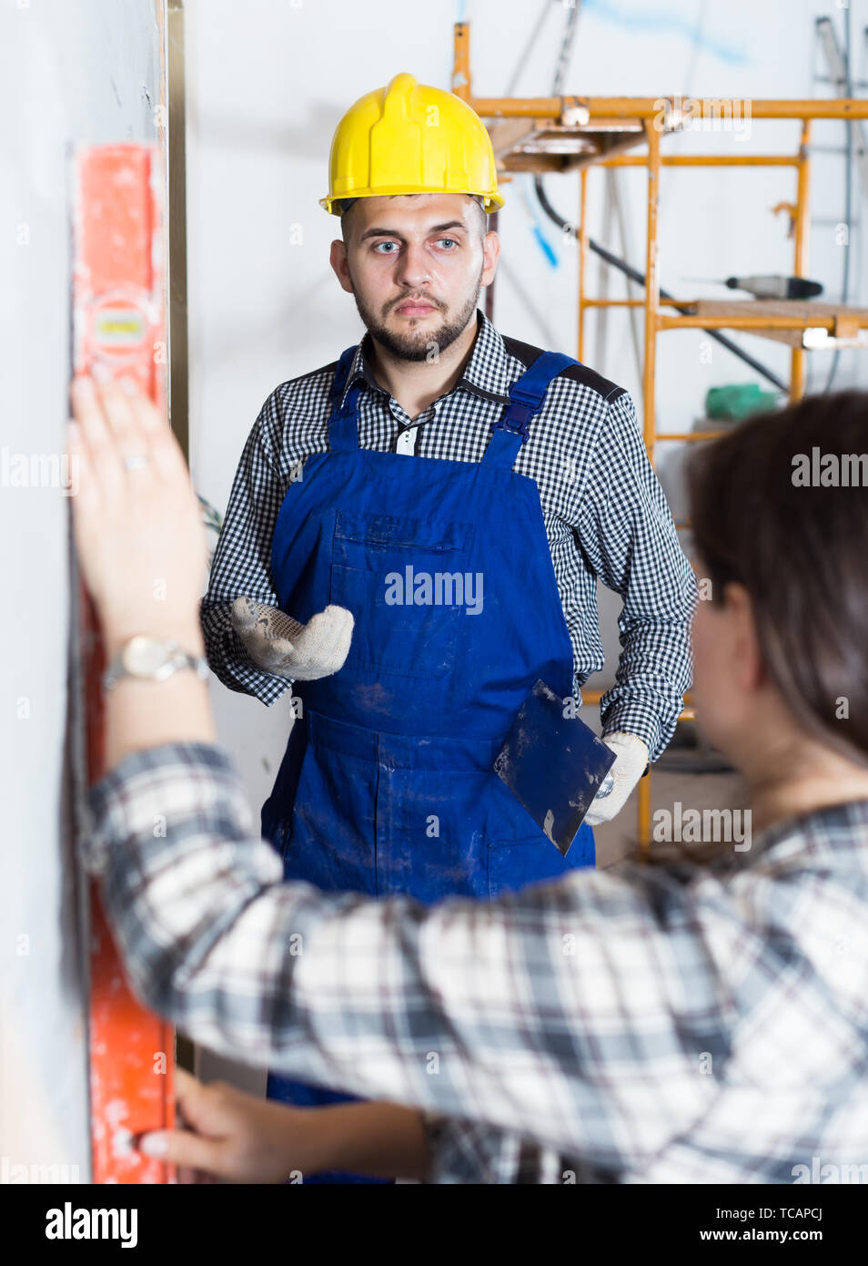 Customer woman is checking what worker done at object Stock Photo - Alamy