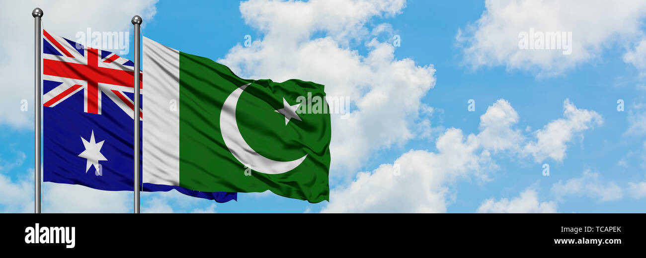 Australia and Pakistan flag waving in the wind against white cloudy ...