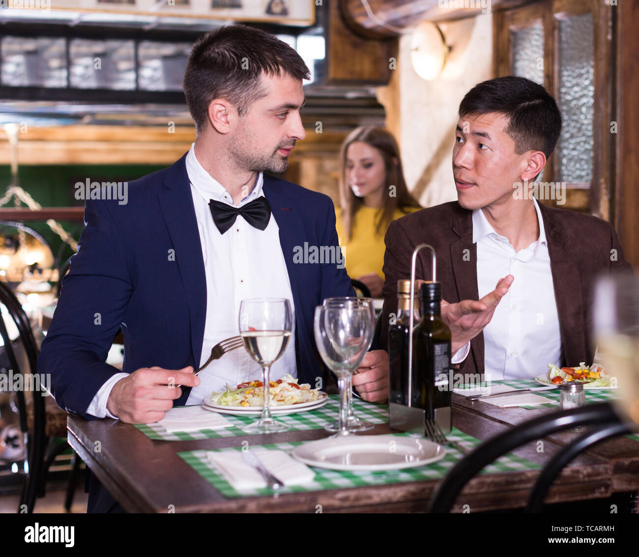 Two businessmen are having dinner in the restaurante indoor Stock Photo ...