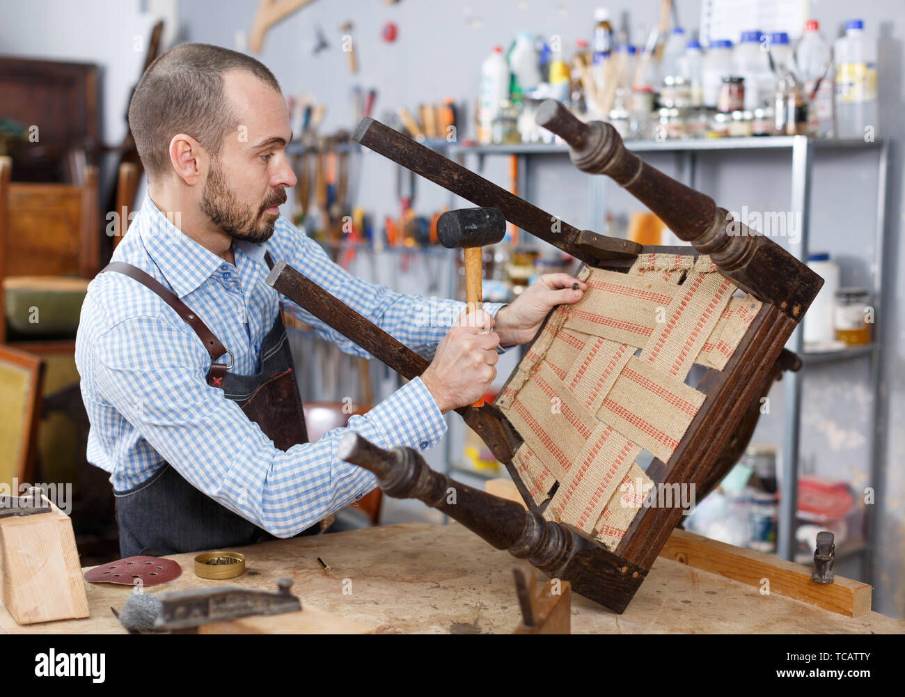 Concentrated craftsman using carpentry tools for restoration old ...