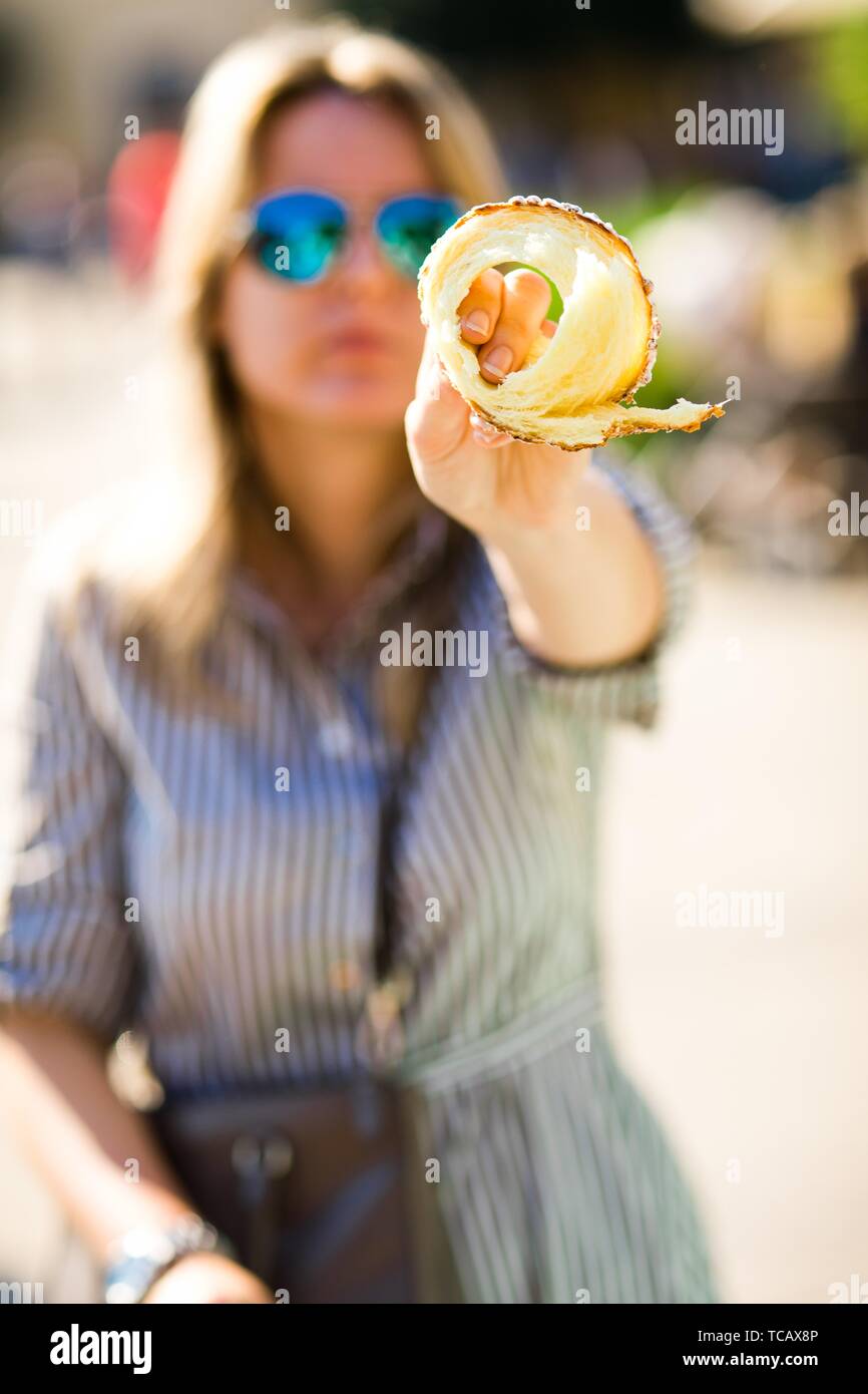Sweet delight, woman is showing piece of Trdelnik, traditional cake ...