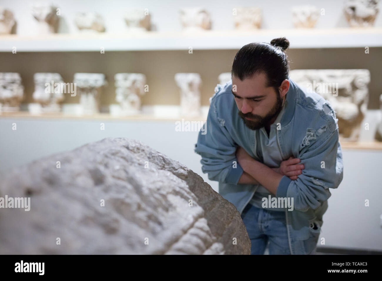 Man visiting sculpture hall in historical museum and looking at ...