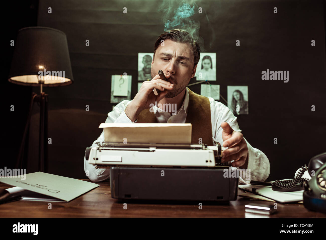 Detective smoking cigar and using typewriter in dark office Stock Photo ...