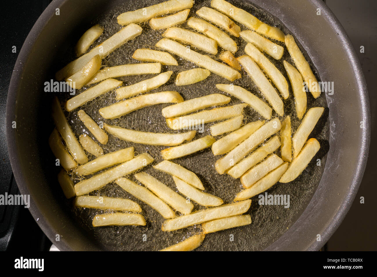 French fries frying Stock Photo - Alamy