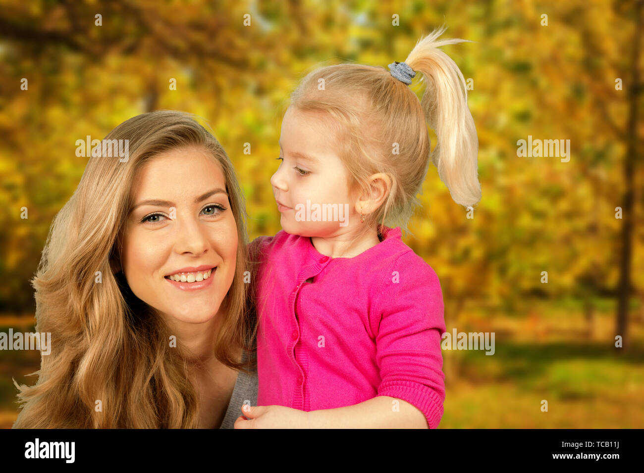 Mother and daughter portrait in autumn park Stock Photo - Alamy