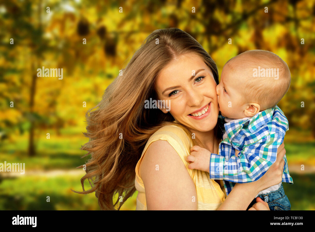 Mother hugging her child during walk in the park Stock Photo - Alamy