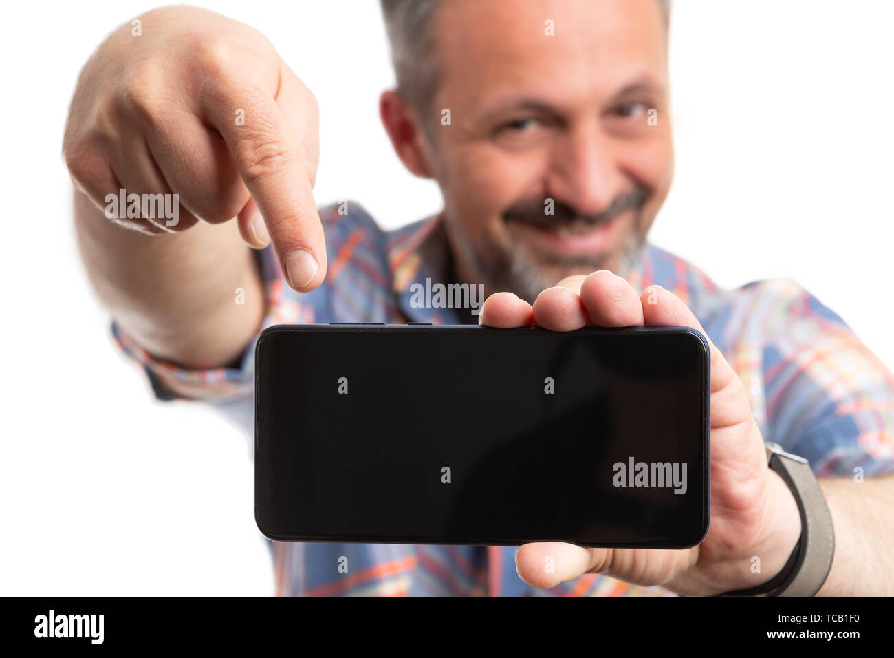 Closeup of smiling man pointing index finger at telephone display ...