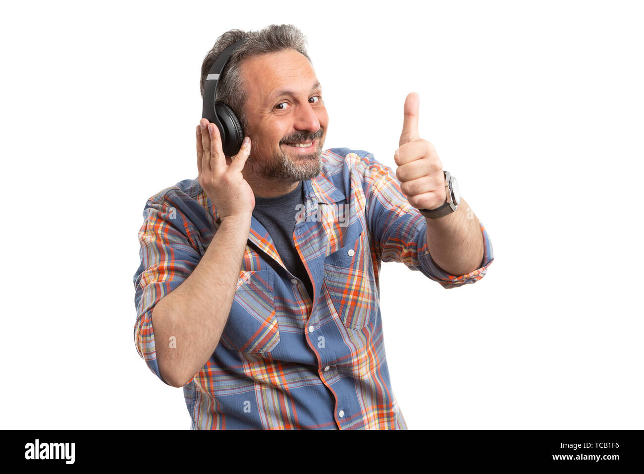 Happy man making thumb up gesture as like while listening to music ...