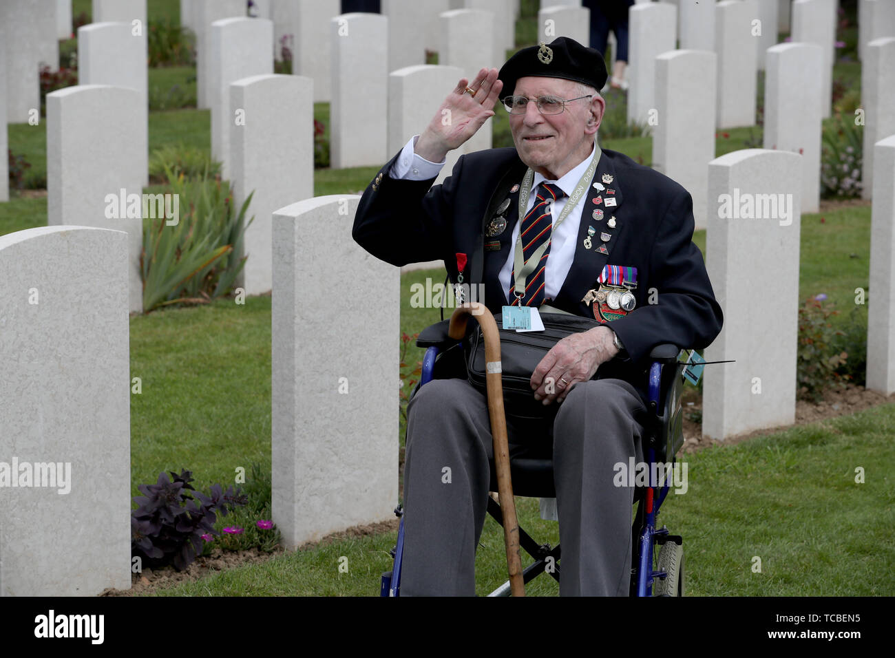A veteran gives a salute amongst the headstones at the Commonwealth War ...