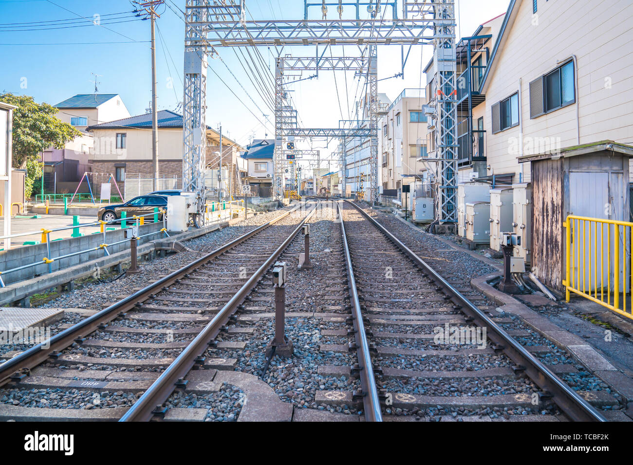 local japanese railroad tracks with home and car parking beside Stock ...