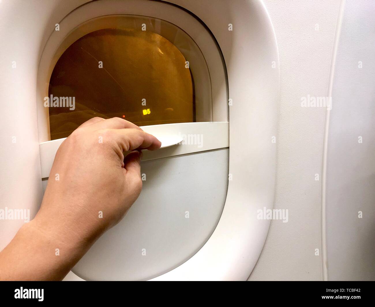 close up hand holding the cover plane window to close and open Stock ...