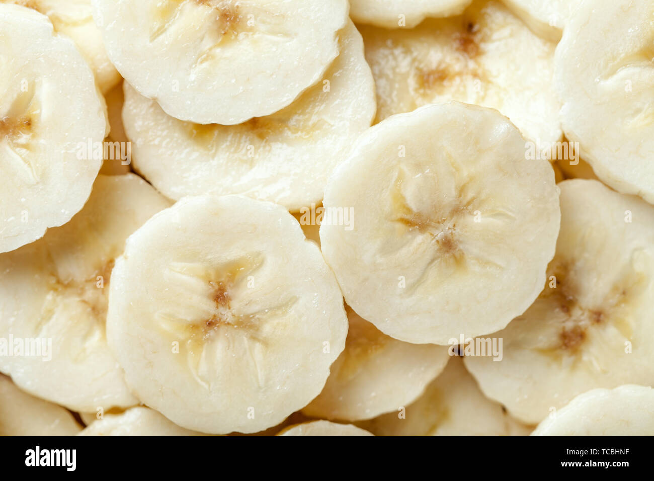 Background of ripe sliced banana slices, closeup. Food backdrop from ...