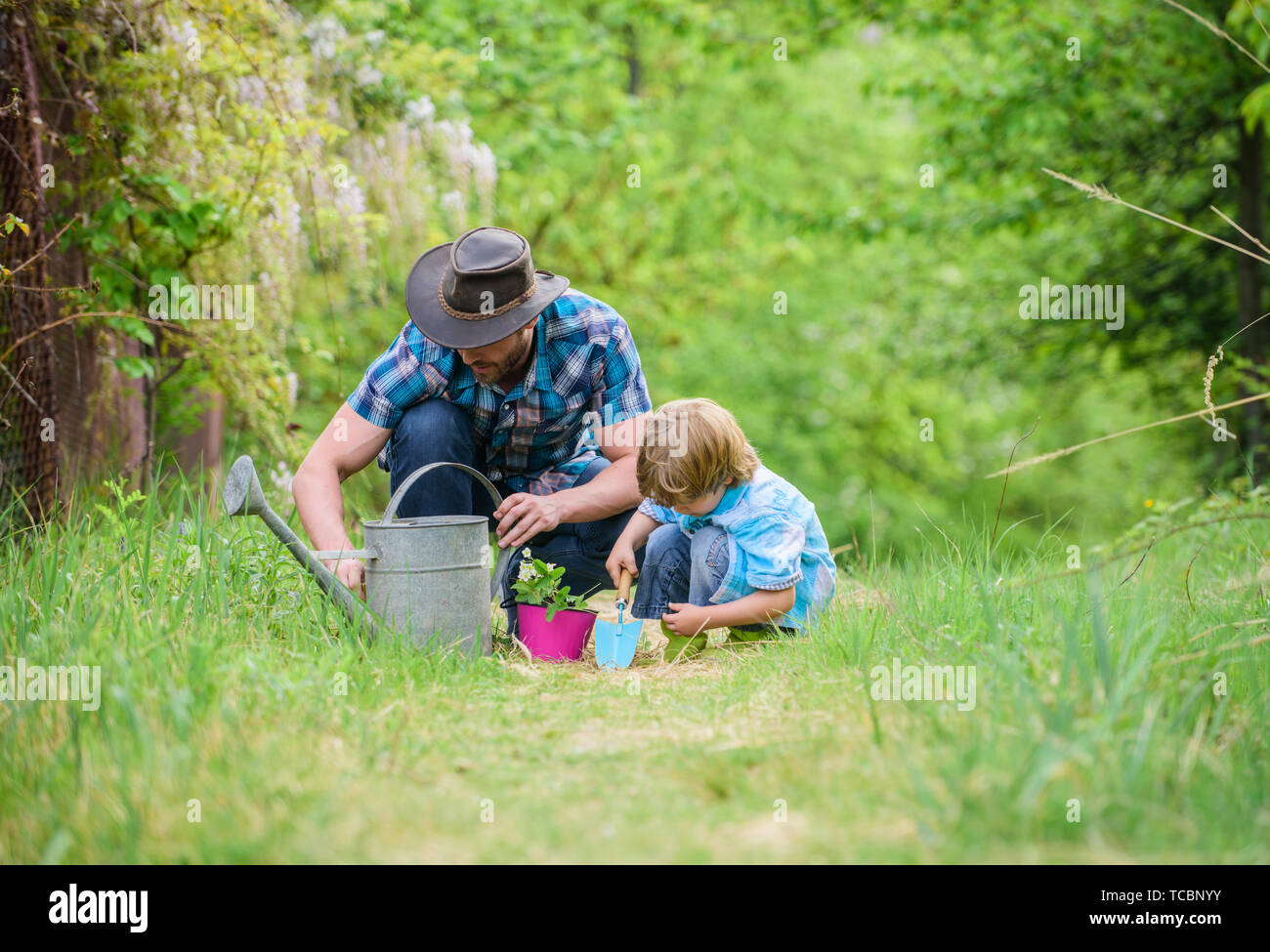 Eco farm. watering can, pot and hoe. Garden equipment. small boy child ...