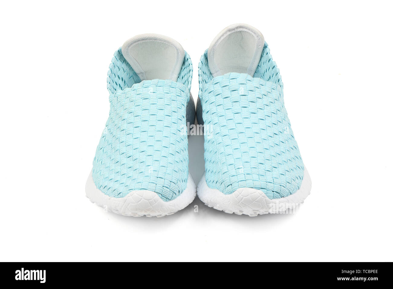 Turquoise rubber sneakers, casual footwear isolated on white background ...