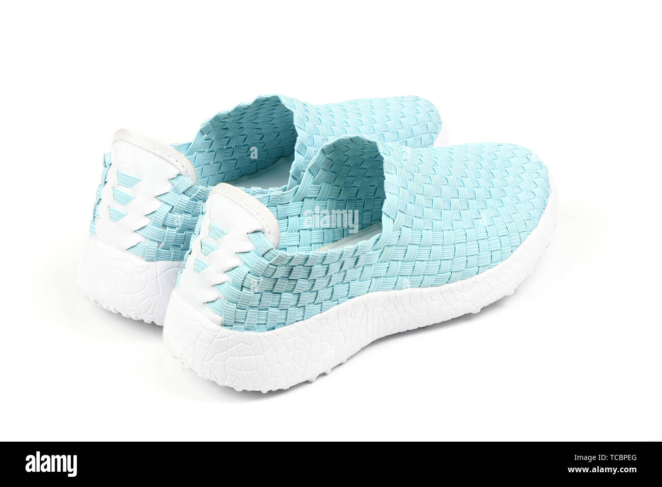 Turquoise rubber sneakers, casual footwear isolated on white background ...