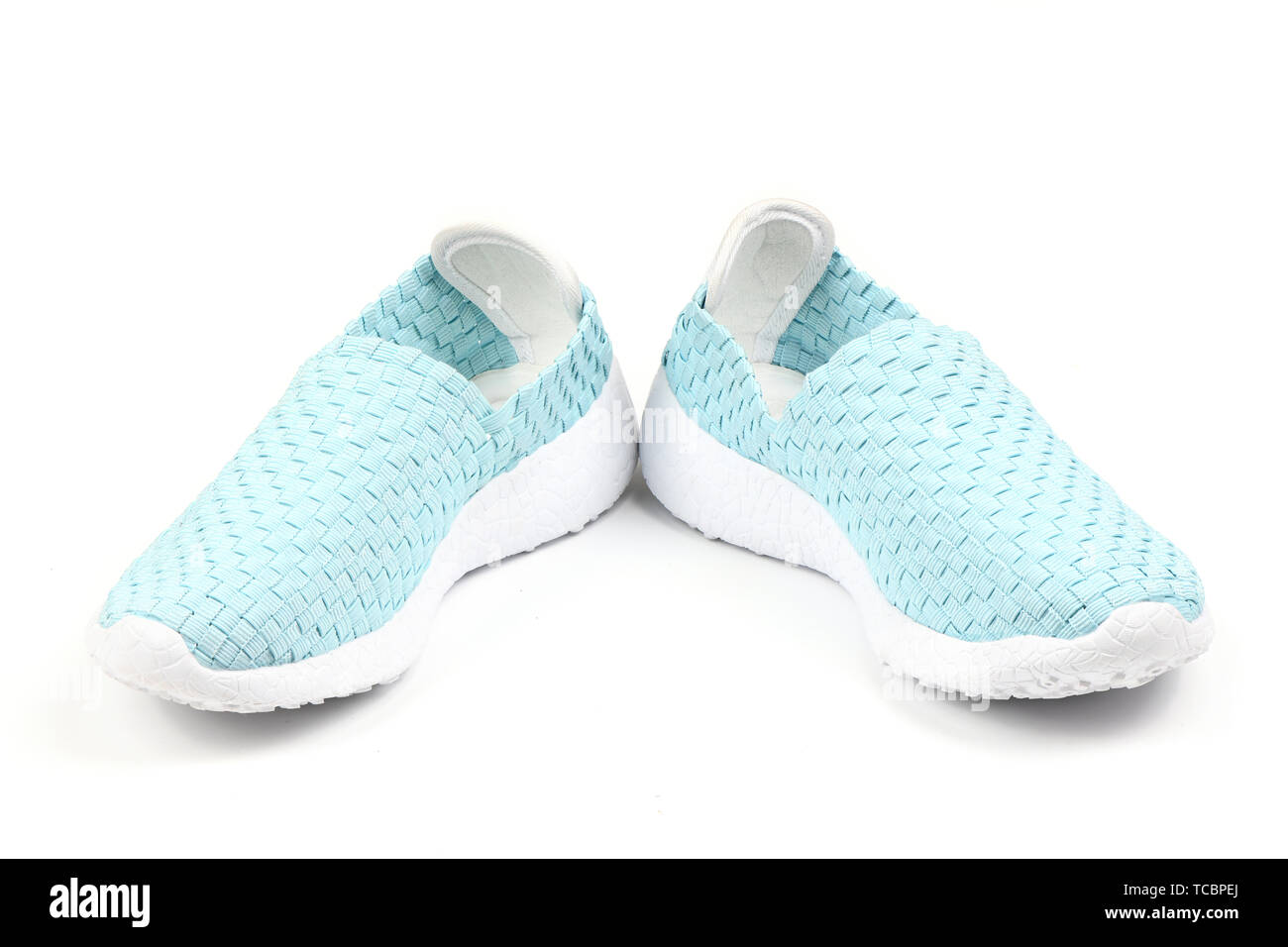 Turquoise rubber sneakers, casual footwear isolated on white background ...