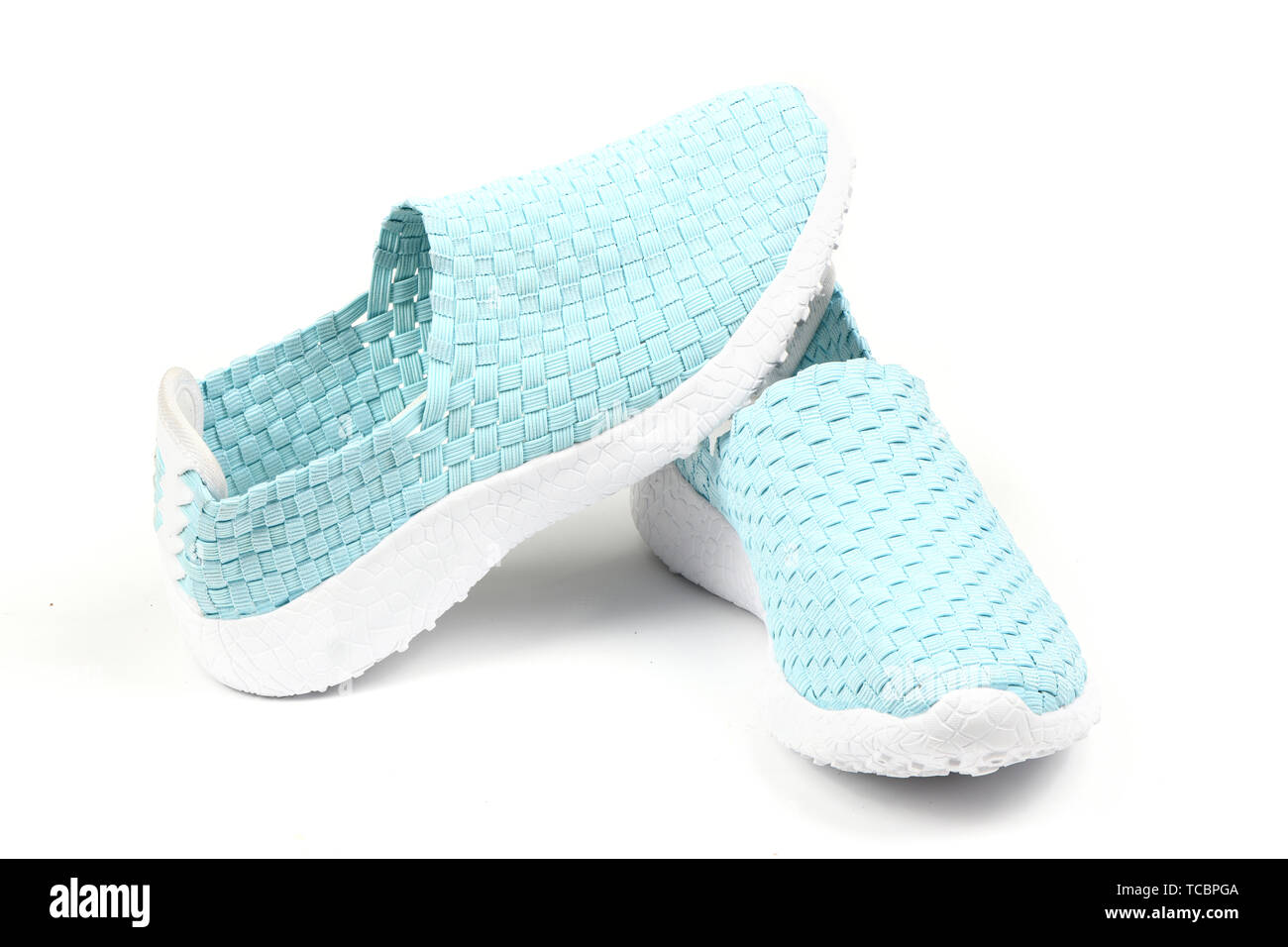 Turquoise rubber sneakers, casual footwear isolated on white background ...