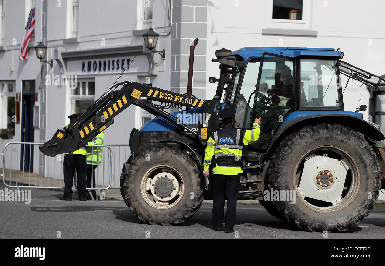 A tractor stops at a Garda checkpoint in the village of Doonbeg, Co ...