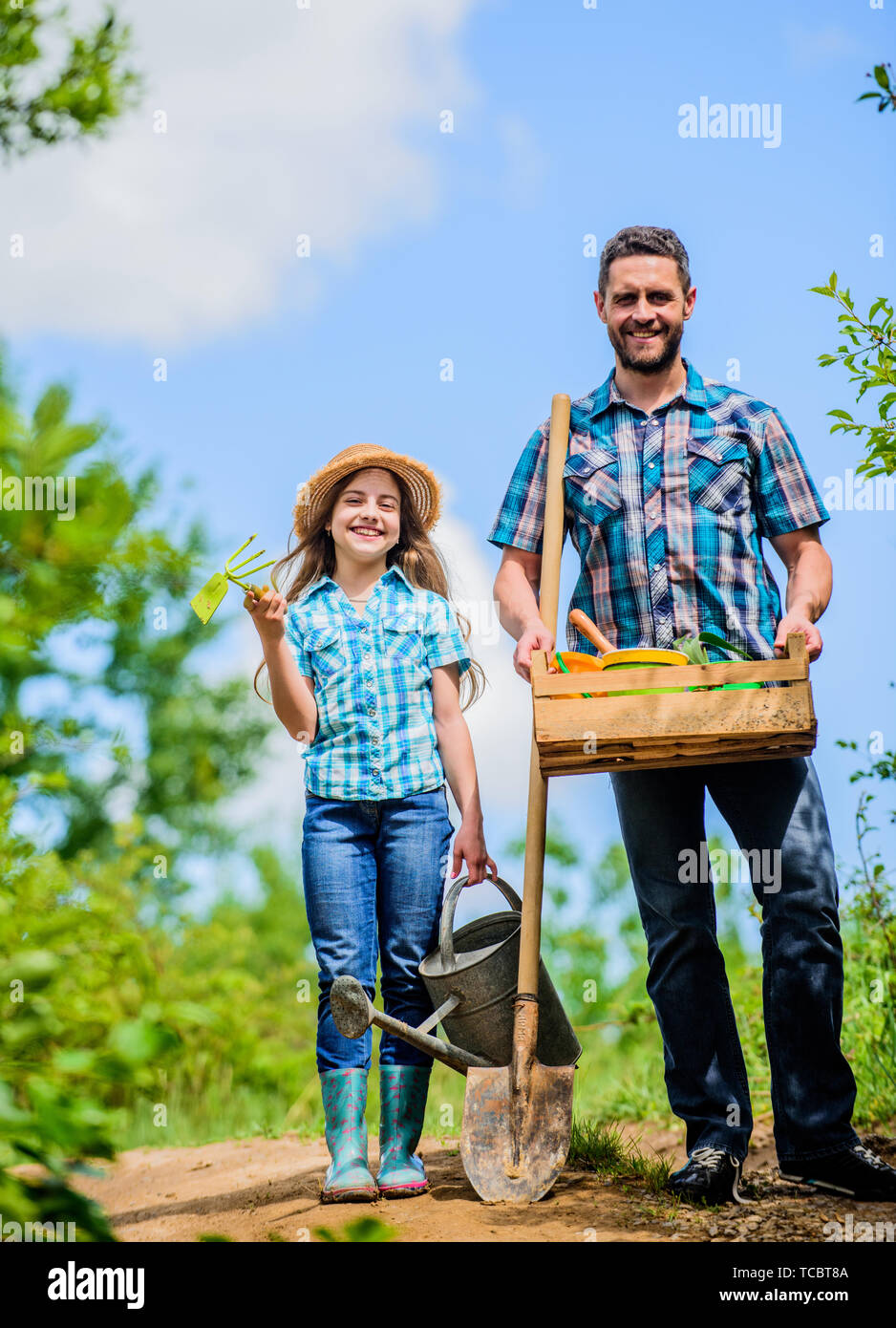 father and daughter on rancho. summer farming. farmer man with little ...