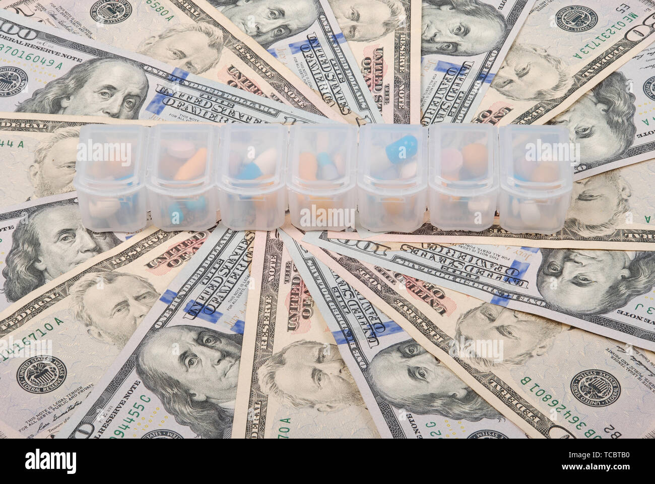 Colored capsules in closed box on money background. Close-up Stock ...