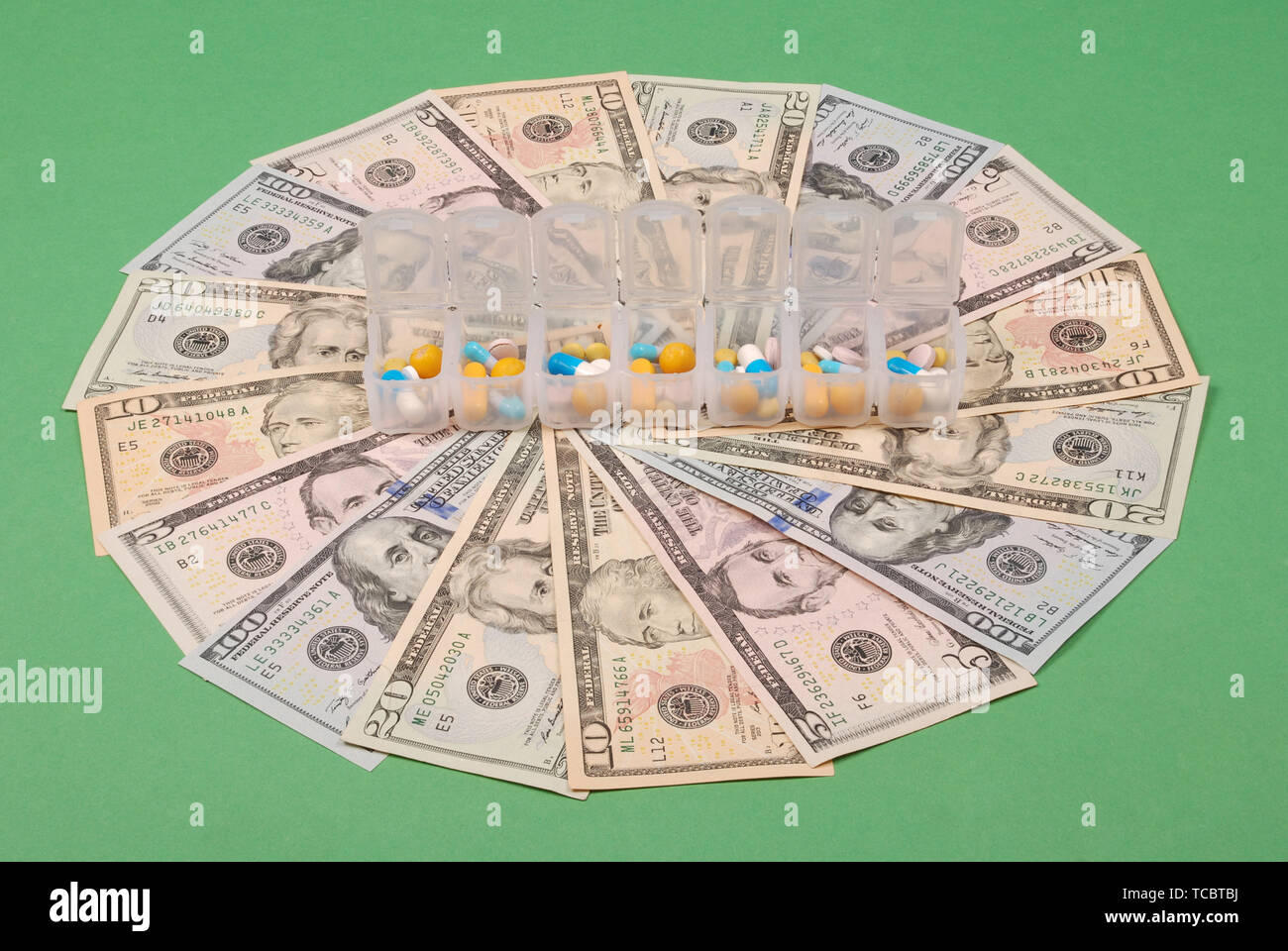 Colored capsules in open box on money, in the shape of a circle ...