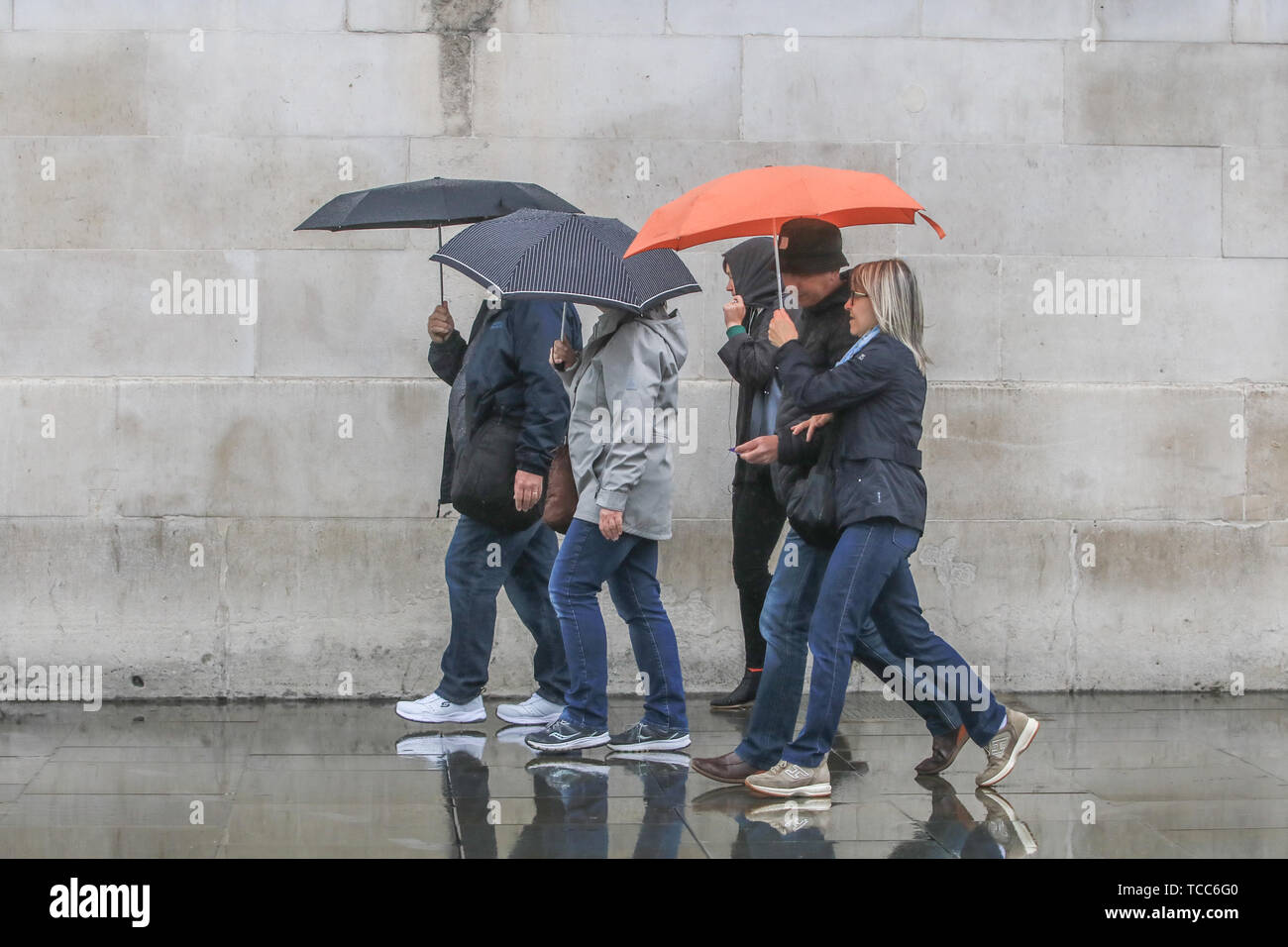 London, UK. 7th June, 2019. Pedestrians battle the adverse weather in ...