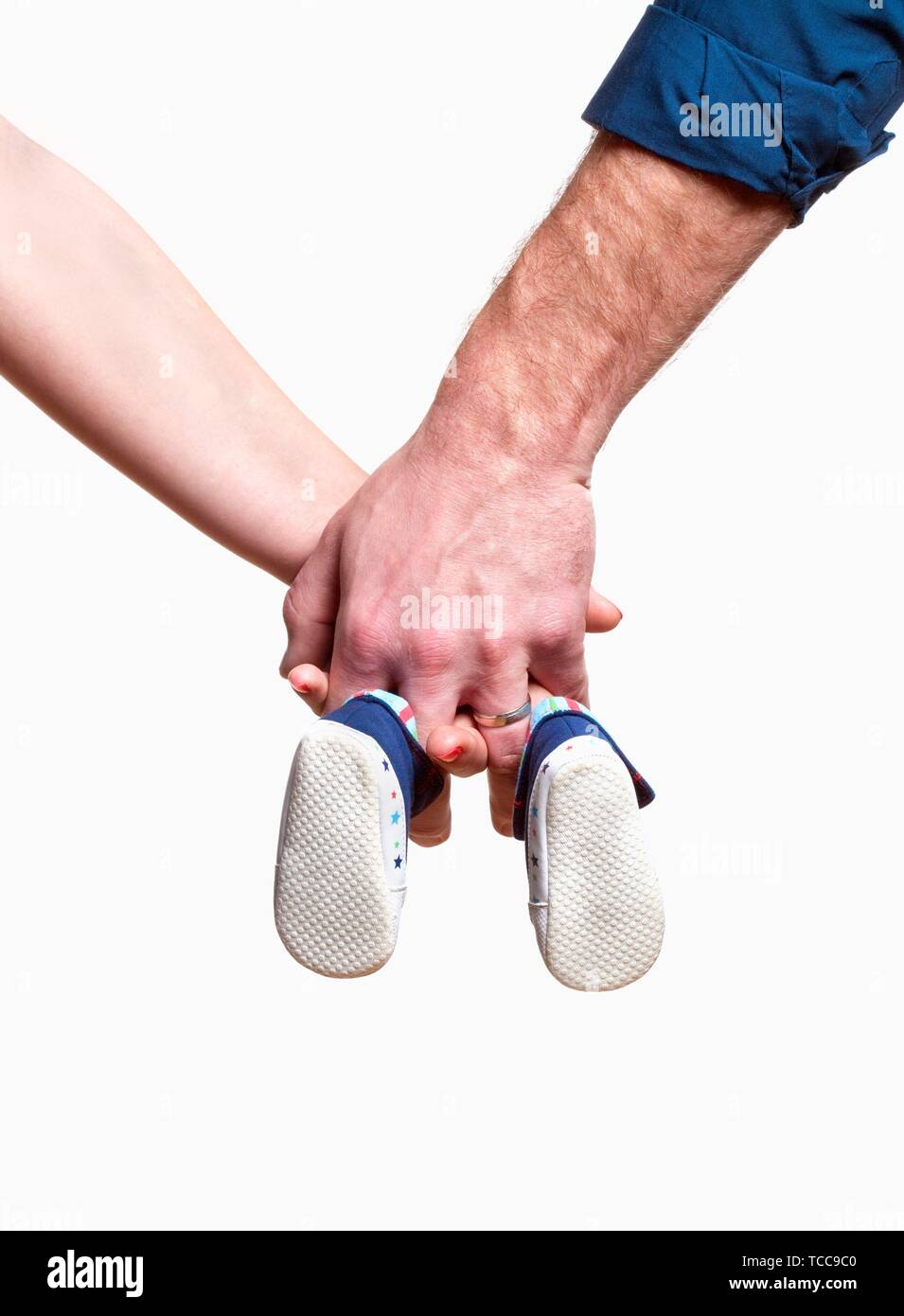 Hand holding shoes hi-res stock photography and images - Alamy