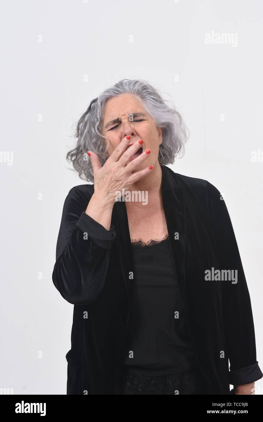 Old senior woman yawning hand hi-res stock photography and images - Alamy