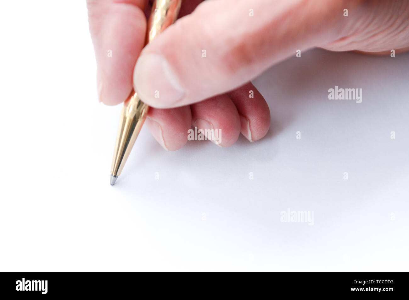 Man writing with pen on paper, close up of hand hollding pen to write ...