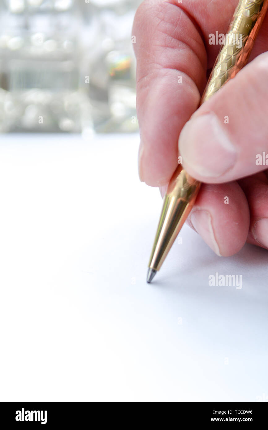 Man writing with pen on paper, close up of hand hollding pen to write ...
