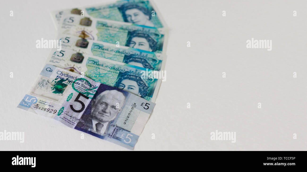 Five pound banknotes on a white background, Bank of Scotland £5 note, a ...