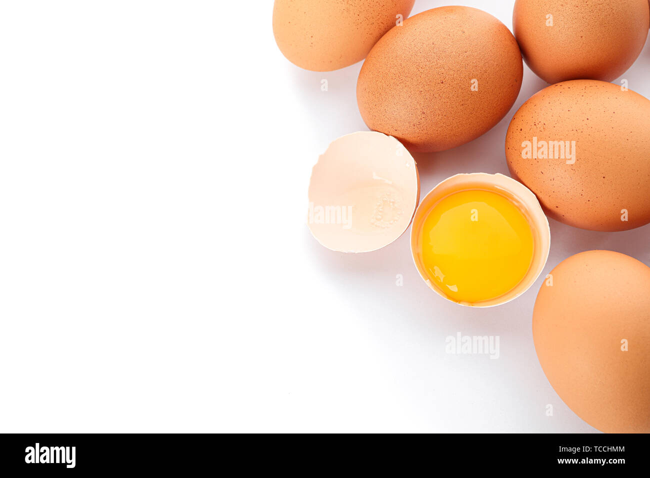 Chicken eggs and half broken egg with yolk isolated on white background ...