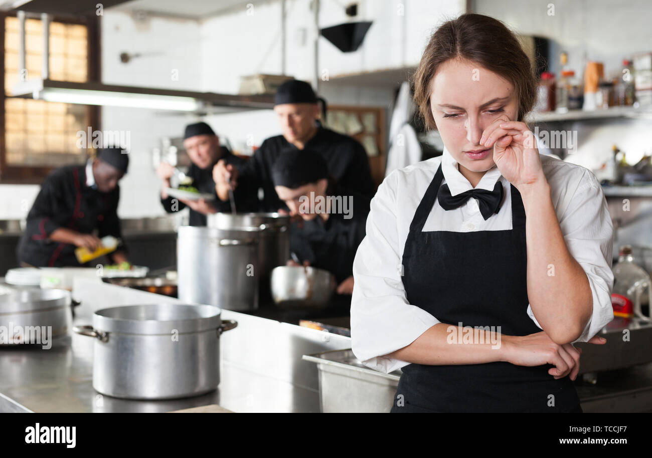 Tired and upset waitress in kitchen of restaurant Stock Photo - Alamy