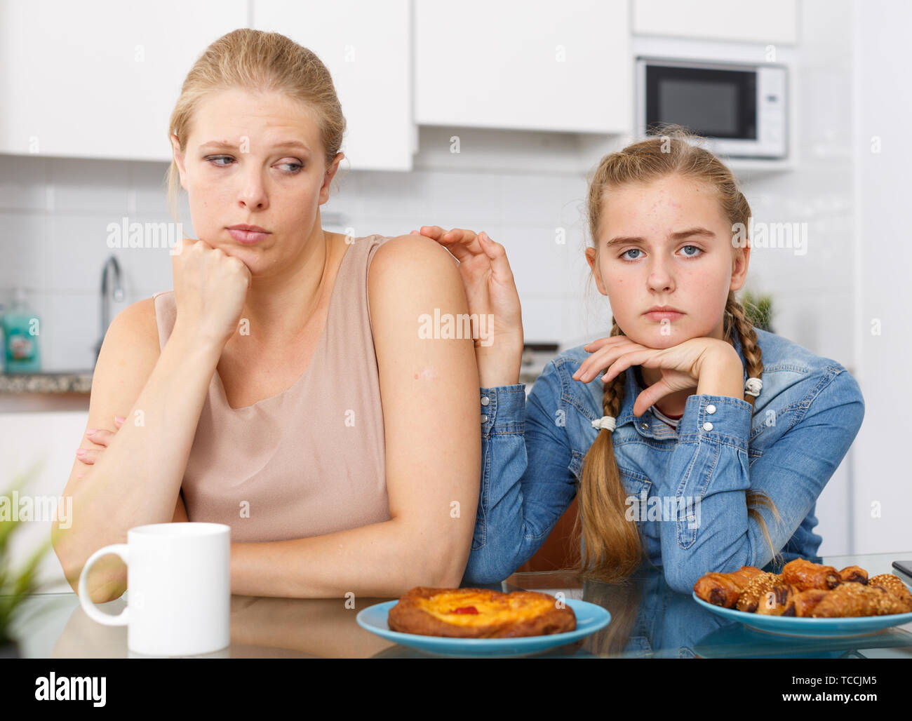 Girl asking for forgiveness from her mother in home interior Stock ...