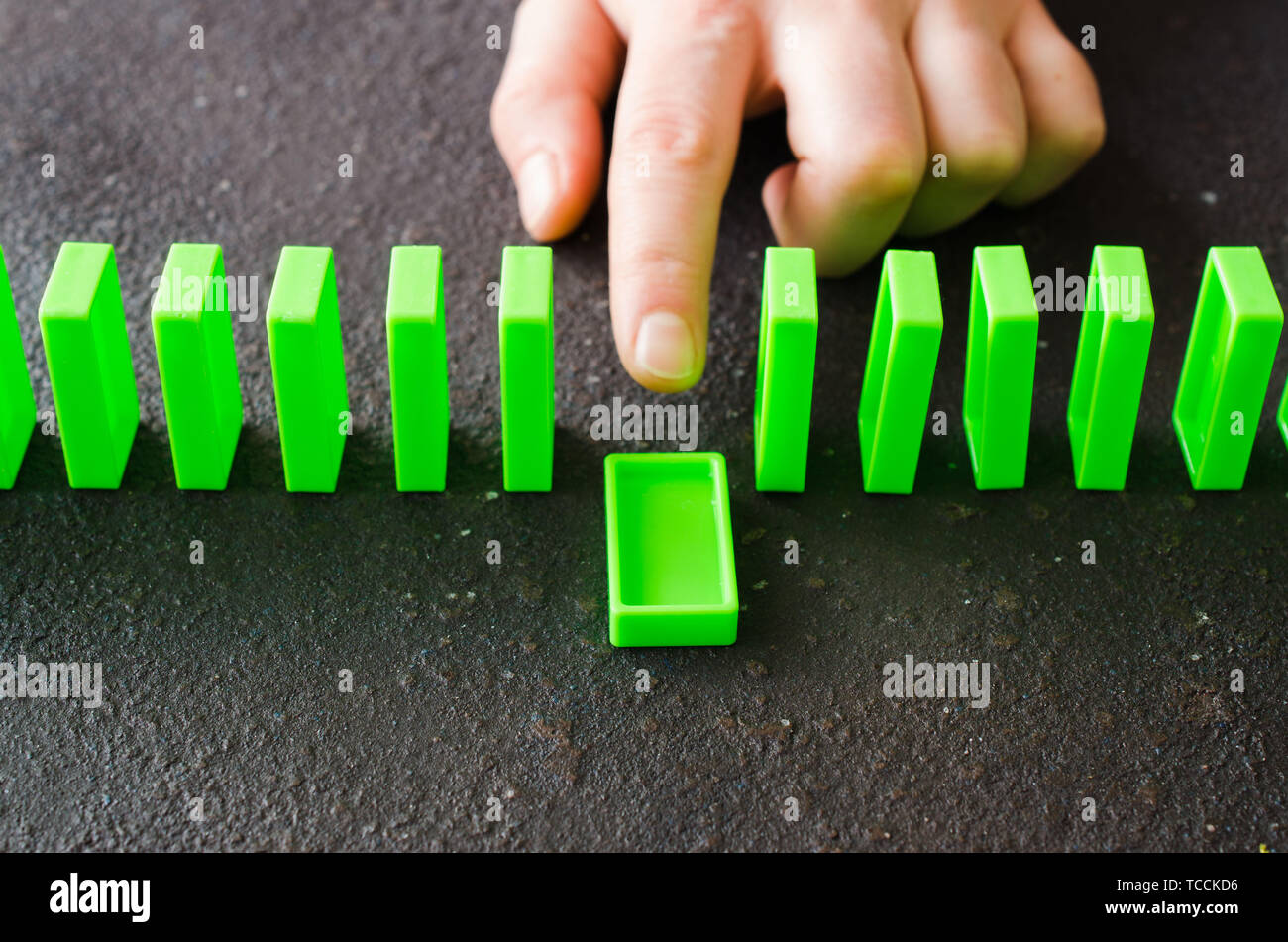 Finger pushing dominoes hi-res stock photography and images - Alamy