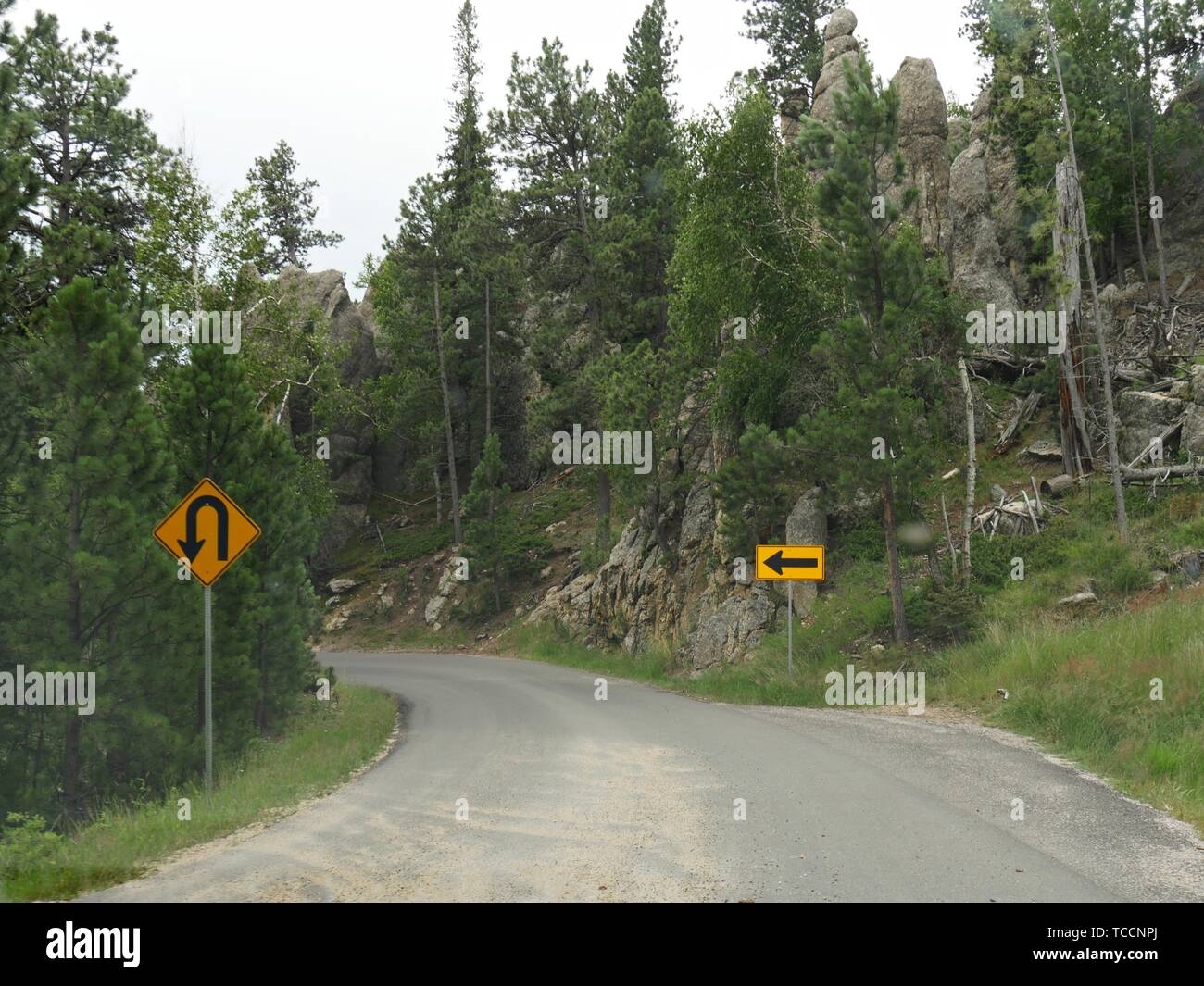 Road signs and arrows along breathtaking twists and rock formations ...