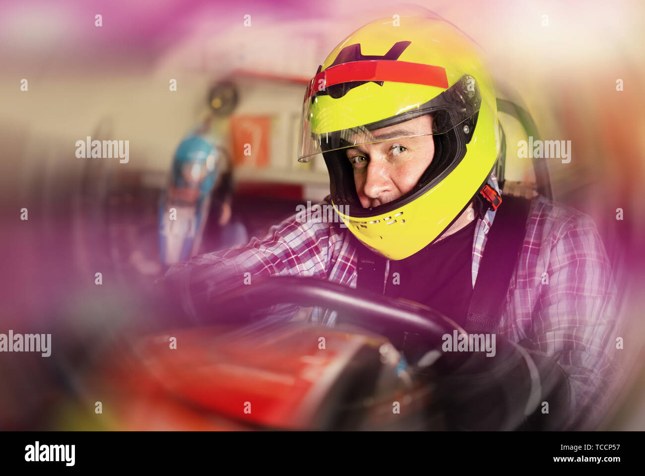 Portrait of nice man driving racing car at kart circuit Stock Photo - Alamy